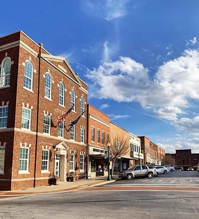 Laurens' city hall stands proudly against that Carolina blue sky, a brick-and-mortar promise that your retirement dollars will stretch like summer evenings here.