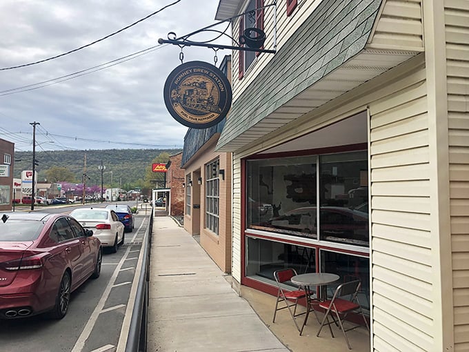 That brewery sign swinging in the mountain breeze promises cold craft beer and warm conversation. The sidewalk table practically begs you to sit a spell.
