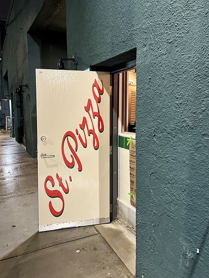 Behind this unassuming door lies pizza paradise &ndash; St. Pizza's entrance is the gateway to flavor heaven.