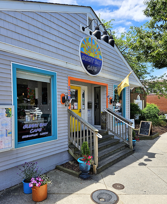 Beach vibes and breakfast dreams merge at Sunny Bay Cafe. That cheery gray-and-yellow exterior promises sunshine on your plate!