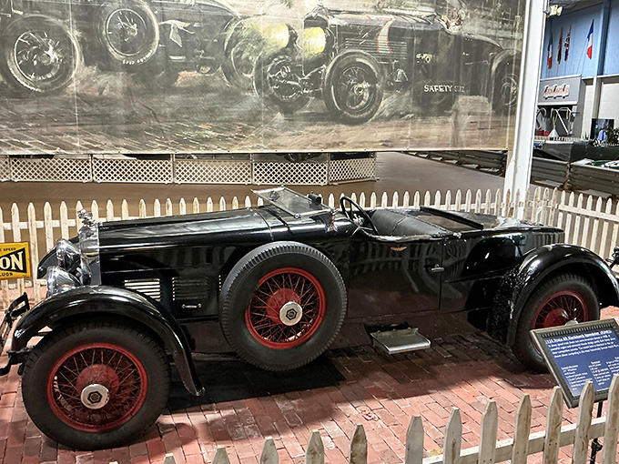 The imposing 1928 Stutz Black Hawk with its gleaming red wheels looks ready to outrun Prohibition agents while keeping its passengers impeccably stylish.