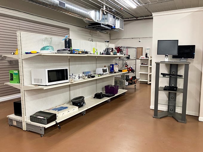 The appliance corner: where microwaves and monitors wait for their second chance at greatness, like actors at a comeback audition.