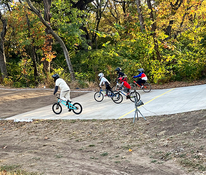 BMX riders catching air at Crestview Park &ndash; where gravity is merely a suggestion and childhood feels wonderfully endless.