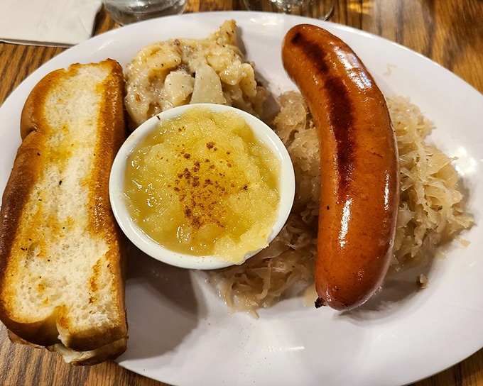A sausage that demands respect, served with sauerkraut and applesauce. The bread isn't just a side&mdash;it's an essential part of the experience. 