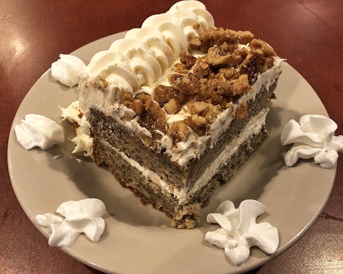 This isn't just banana cake&mdash;it's an architectural achievement. Layers of happiness topped with walnuts and surrounded by whipped cream sentinels.