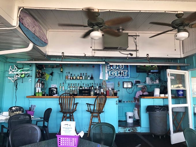 The bar's turquoise walls and weathered charm create the perfect backdrop for stories that get better with each retelling.