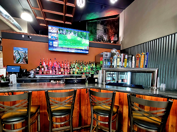 The bar area balances rustic charm with modern touches, offering a front-row seat to the controlled chaos of a busy kitchen.