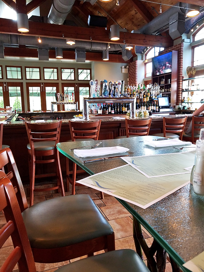 The bar area combines industrial chic with waterfront warmth &ndash; those tap handles stand ready like soldiers awaiting orders for the next perfect pour.