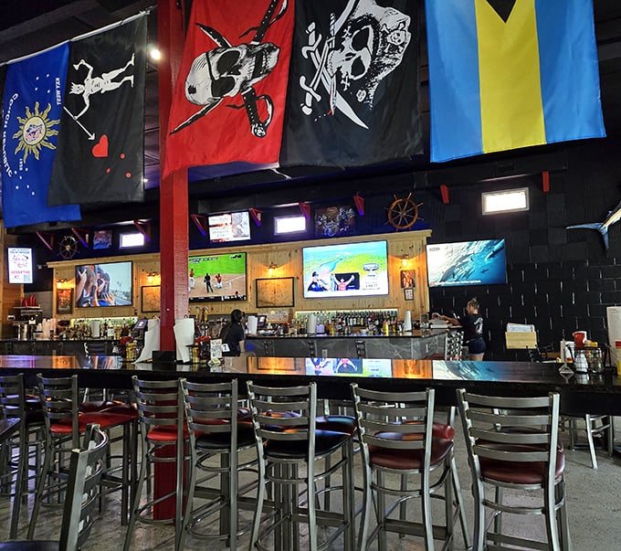 The bar area flies its flags proudly, offering liquid courage and conversation beneath pirate banners that say "abandon your diet, all ye who enter here."