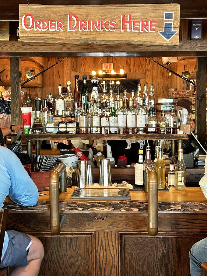 The bar's rustic charm says "order something with bourbon" &ndash; a wooden shrine to libations where bartenders work their magic.