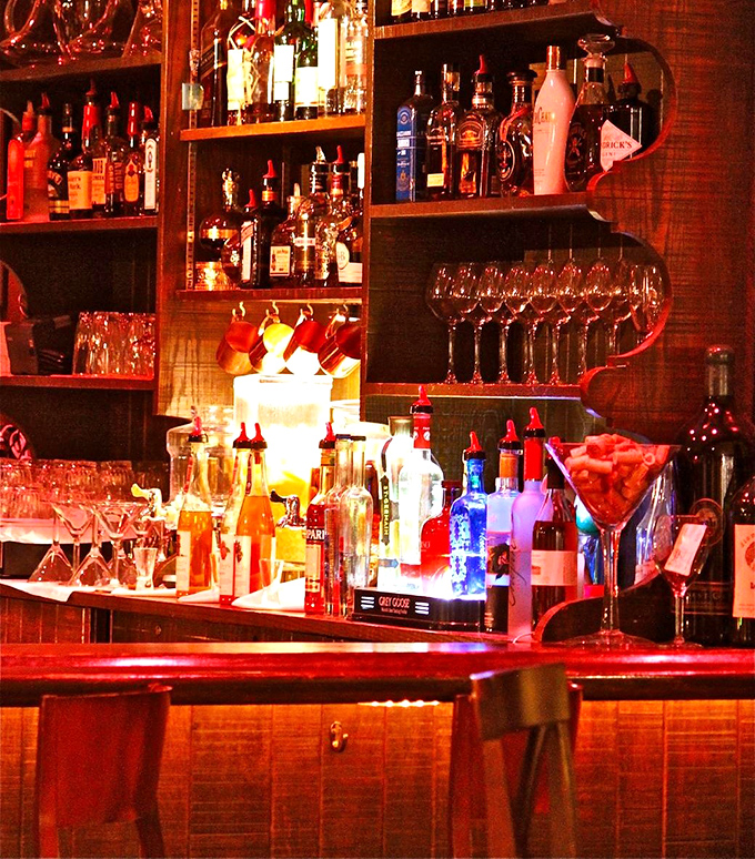 Behind every great meal is a well-stocked bar with bottles that tell stories. The warm glow promises libations crafted with care and precision.