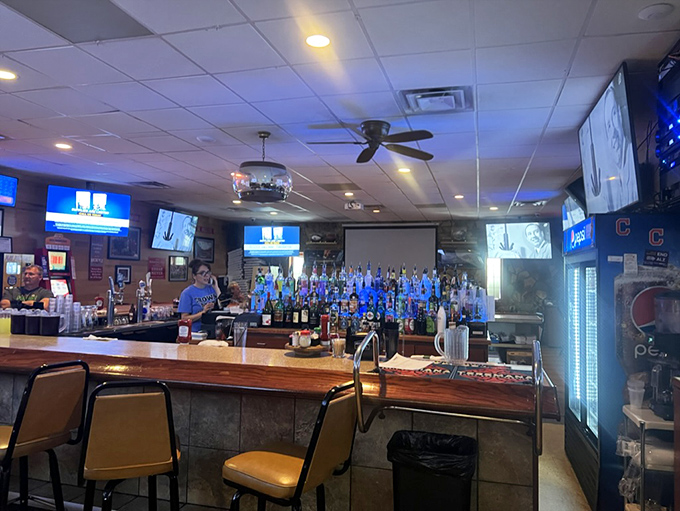 The bar area glows with possibility. Those illuminated bottles aren't just decoration - they're a promise of good times ahead.