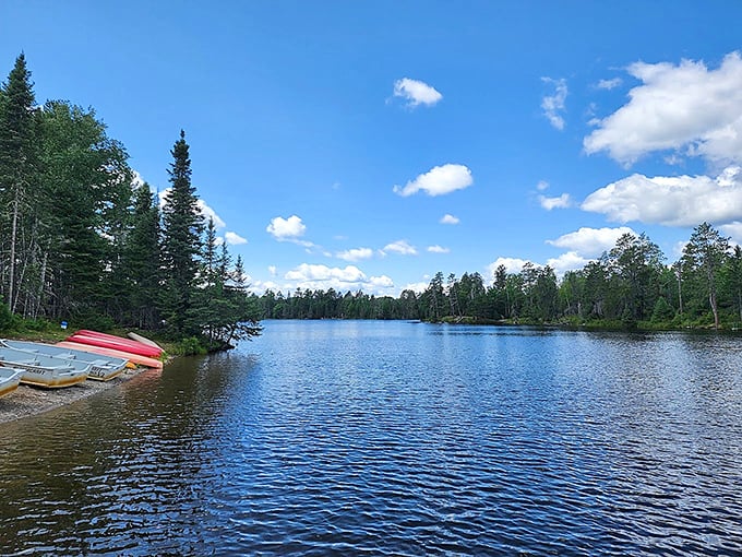 Mirror-like waters reflect an endless sky at Bear Head Lake, where canoes wait patiently for the next adventure to begin.