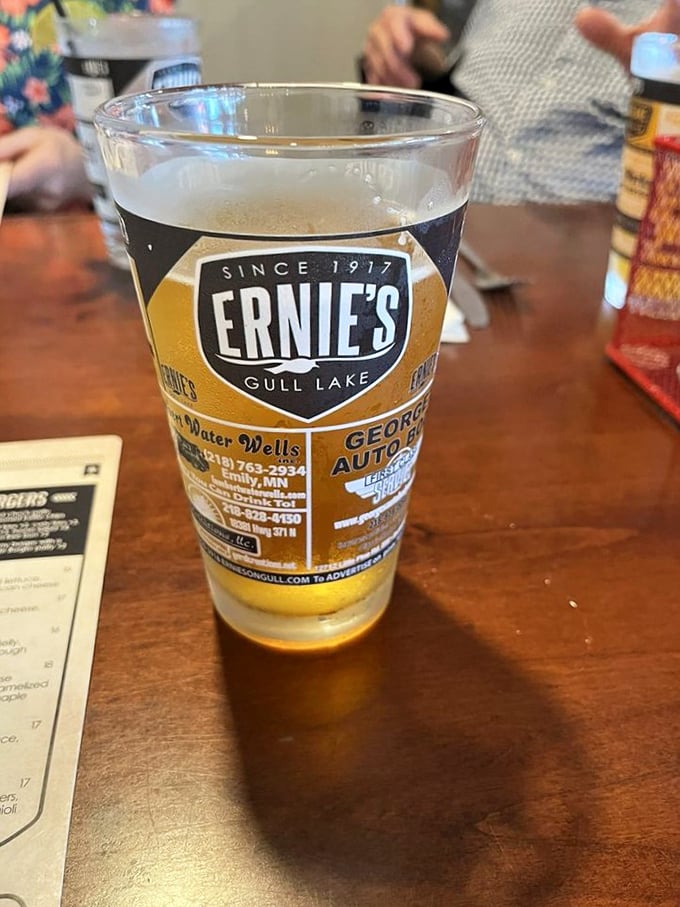 Sipping local brew from a branded glass while the Ernie's logo reminds you exactly where this memory is being made.