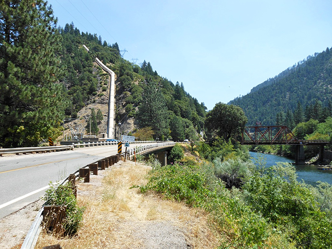 Where highway meets river in a dance that's been ongoing for decades. The water always leads, but the road follows with grace.