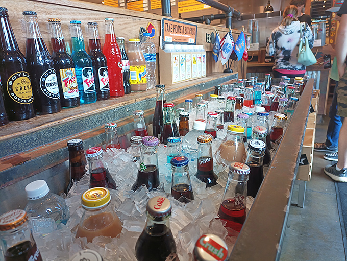 An impressive array of bottled sodas chilling on ice, offering nostalgic refreshment options that transport you straight back to simpler times.