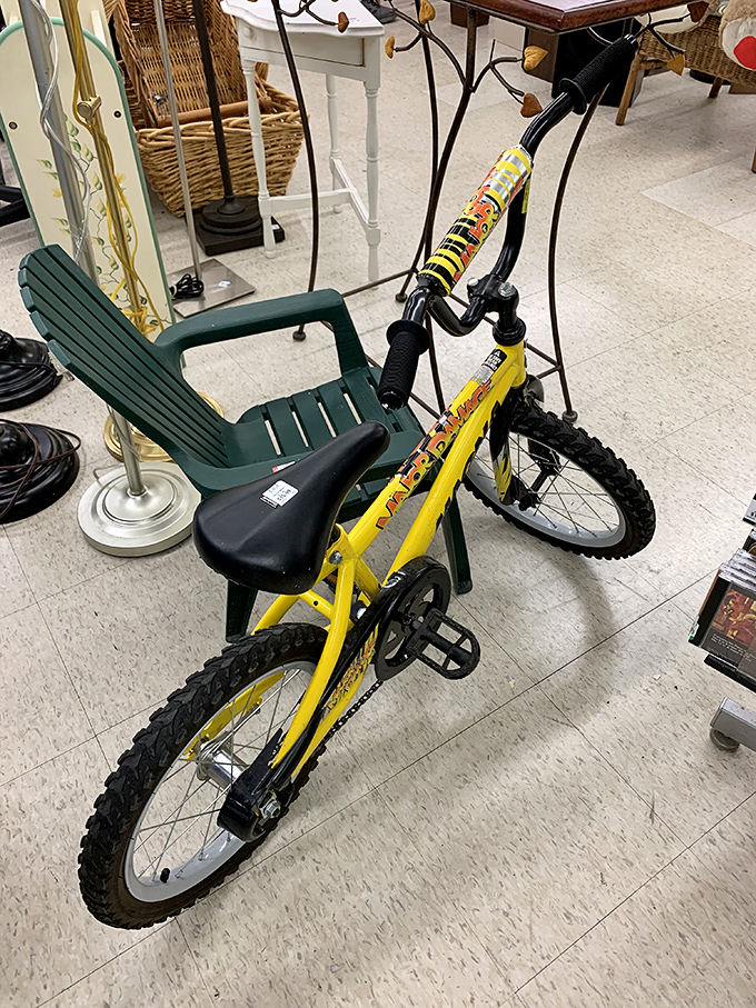 A bright yellow kid's bicycle ready to create summer memories without draining anyone's college savings fund.
