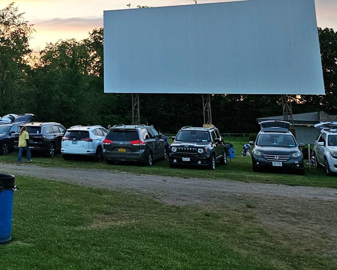 Twilight's magic hour—when cars become cocoons and the massive screen awakens. The moment every drive-in goer waits for with childlike anticipation.