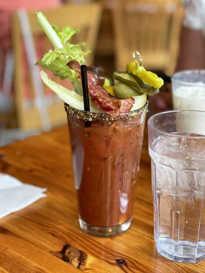 A Bloody Mary that's practically a meal, garnished with enough vegetables to count as your daily serving. That bacon strip is just showing off.