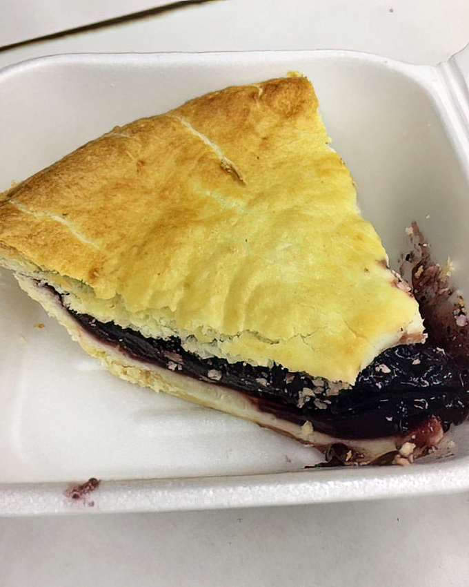 A slice of blueberry pie that doesn't need to be photographed for Instagram—it was delicious long before social media existed.