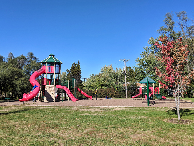 This playground's bright slides and climbing towers stand ready for the universal childhood joy of conquering the tallest structure in sight.