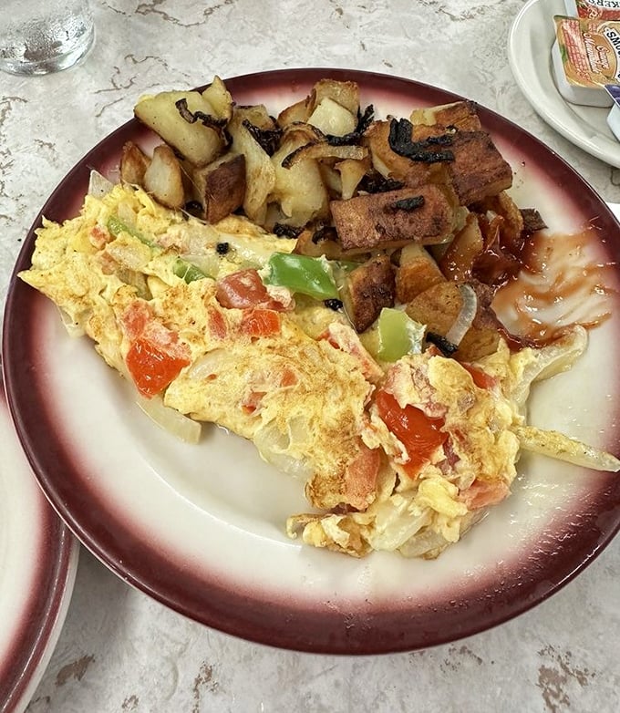 A breakfast plate that answers the eternal question: "Why choose?" Eggs, potatoes, and whatever else your morning heart desires.