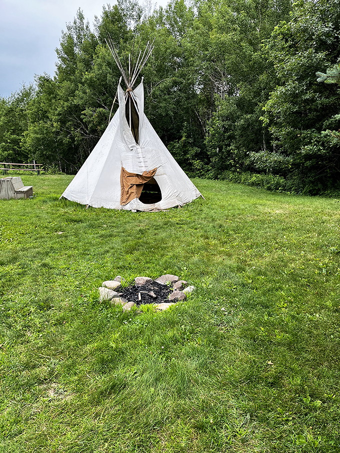 Indigenous wisdom meets modern camping in this peaceful tipi setting. The stone fire circle completes this picture of cultural heritage and outdoor connection.