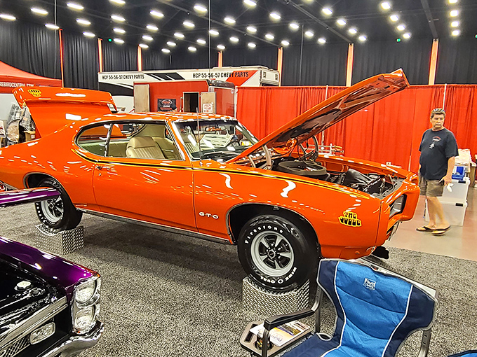 Classic cars gleam under showroom lights, offering a chrome-filled detour from shopping that husbands mysteriously never rush through.
