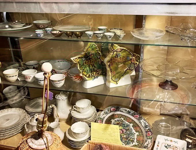 Delicate china and decorative plates wait patiently for their second act in someone's collection. Yesterday's table settings, tomorrow's treasures.