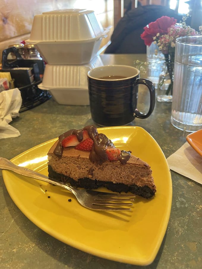 A slice of chocolate strawberry cheesecake that makes a compelling argument for dessert being an acceptable breakfast food.