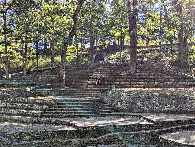 The stone amphitheater rises from the forest floor like nature's own concert hall, designed by time and mountain craftsmanship.