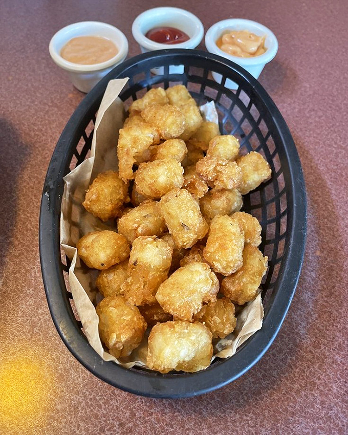 Golden-brown tots huddle together in their basket, waiting for their dipping destiny. Crispy outside, fluffy inside&mdash;potato perfection in bite-sized form.