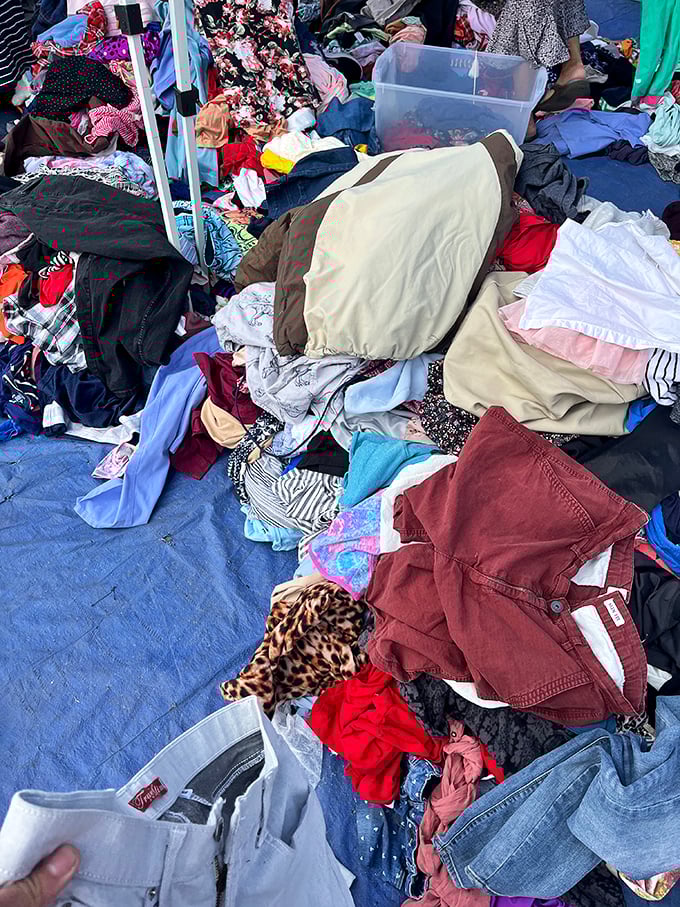 The clothing mountain beckons brave explorers. Somewhere in this textile treasure trove hides the perfect pair of jeans or vintage band tee.
