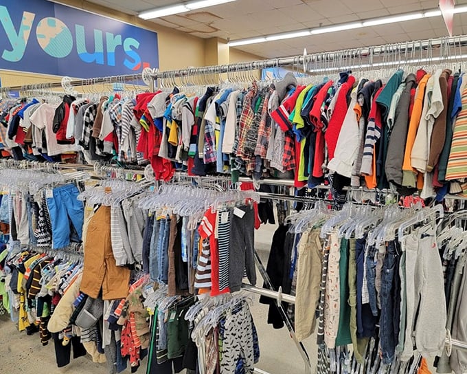 Children's clothing organized by size and color &ndash; proof that thrift store shopping isn't chaos, it's a carefully curated experience.