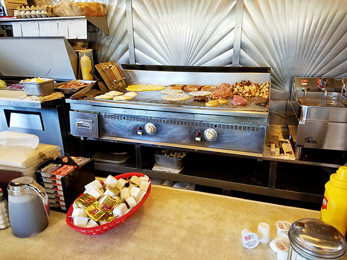 The grill sizzles its morning symphony while hash browns achieve their crispy destiny right before your eyes.