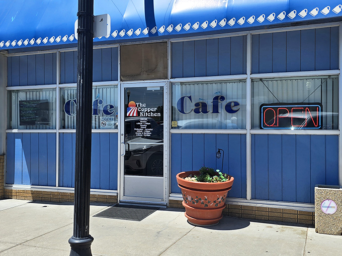 The Copper Kitchen Cafe's blue exterior is like a calm oasis in a desert of chain restaurants. That terra cotta planter isn't just decorative&mdash;it's practically the ma&icirc;tre d'.