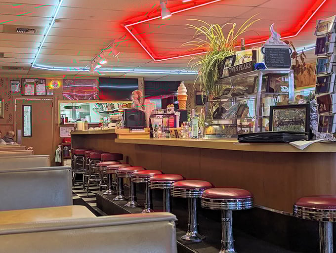 The counter where dreams come true, one coffee refill at a time. Those red stools have heard a million stories.