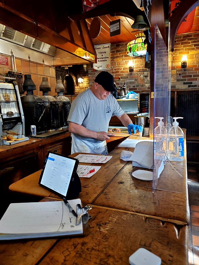 Behind the counter, where burger magic happens with practiced efficiency and zero pretension, just as it has for generations.