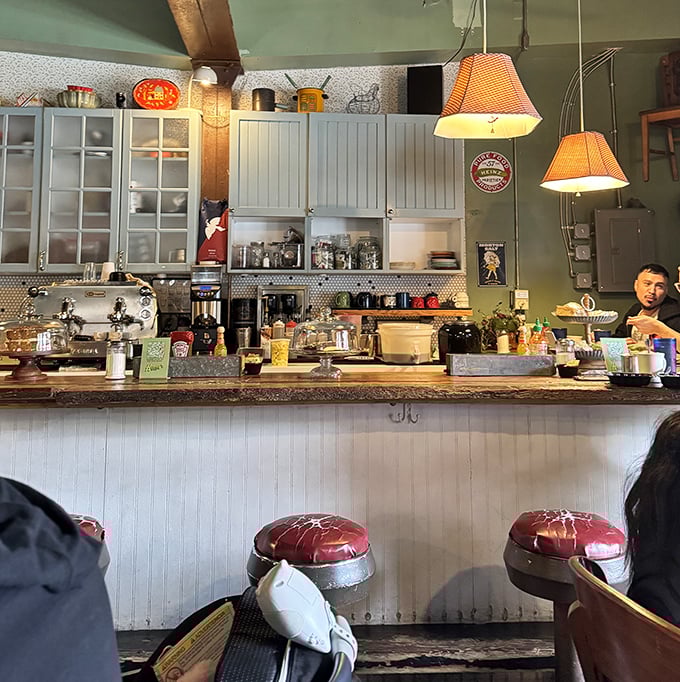 Behind the counter, organized chaos creates breakfast magic in a space that feels more like a friend's kitchen than a commercial restaurant.
