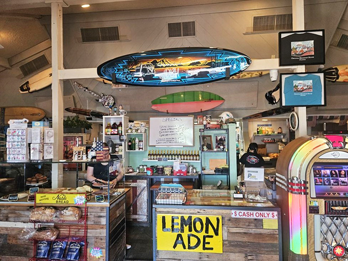 The counter area showcases surfboards overhead and homemade lemonade signs below &ndash; beach vibes in the desert that somehow make perfect sense.