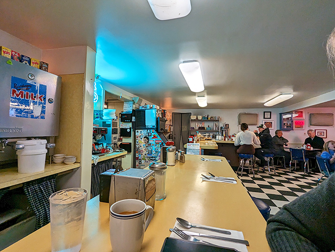 The counter where strangers become friends over coffee refills. That classic checkerboard floor has witnessed countless "I'll just have one more bite" moments.