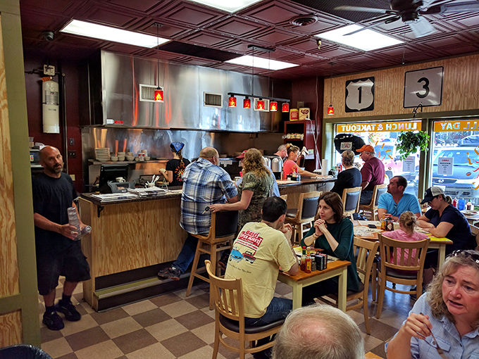 Where the magic happens: the counter and open kitchen create that perfect diner symphony of sizzles, clanks, and friendly chatter. Breakfast theater at its finest.