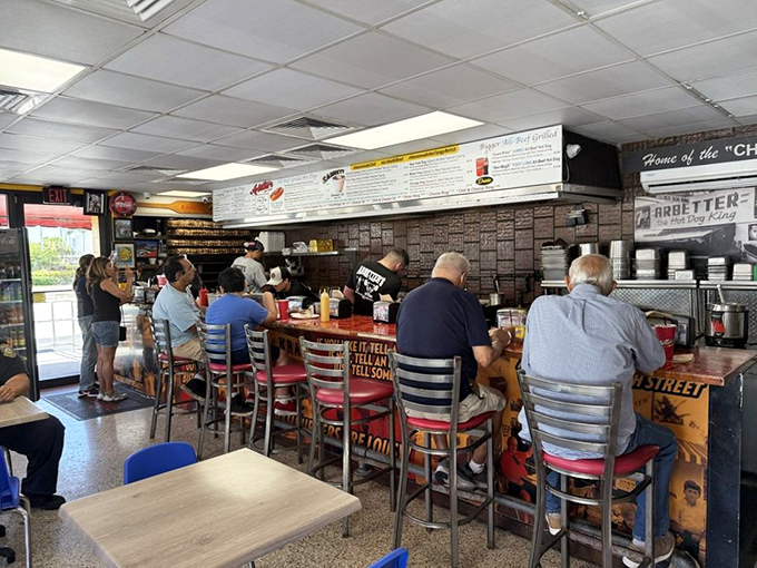 The counter seating offers front-row tickets to the hot dog symphony, where regulars and newcomers share the same delicious experience.