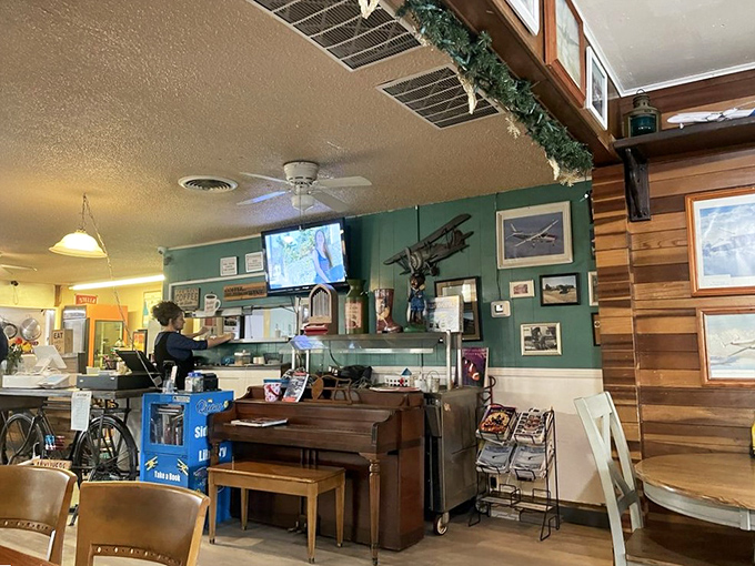 The counter area where coffee cups are always full and the staff remembers how you like your eggs without asking. Aviation memorabilia watches over it all.