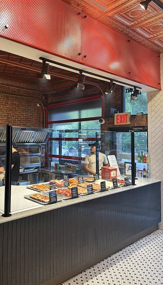 The counter where pizza dreams come true. That ornate ceiling above modern display cases creates the perfect backdrop for your moment of decision.