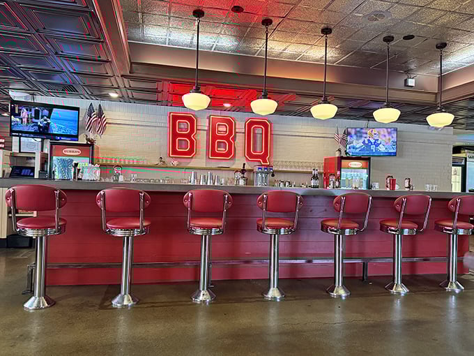 Those red counter stools aren't just seating &ndash; they're front-row tickets to the BBQ show, complete with neon lighting that says "good decisions happen here."