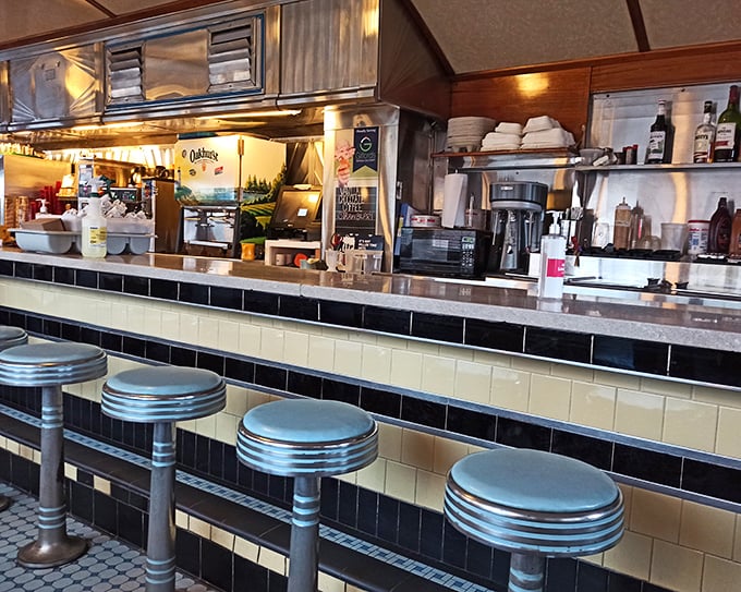 The black and cream tiled counter front is the stage where diner magic happens &ndash; where coffee cups never reach empty and conversation flows freely.