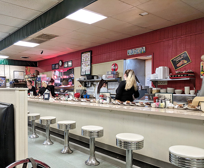 Classic diner counter with chrome stools where conversations flow as freely as coffee.