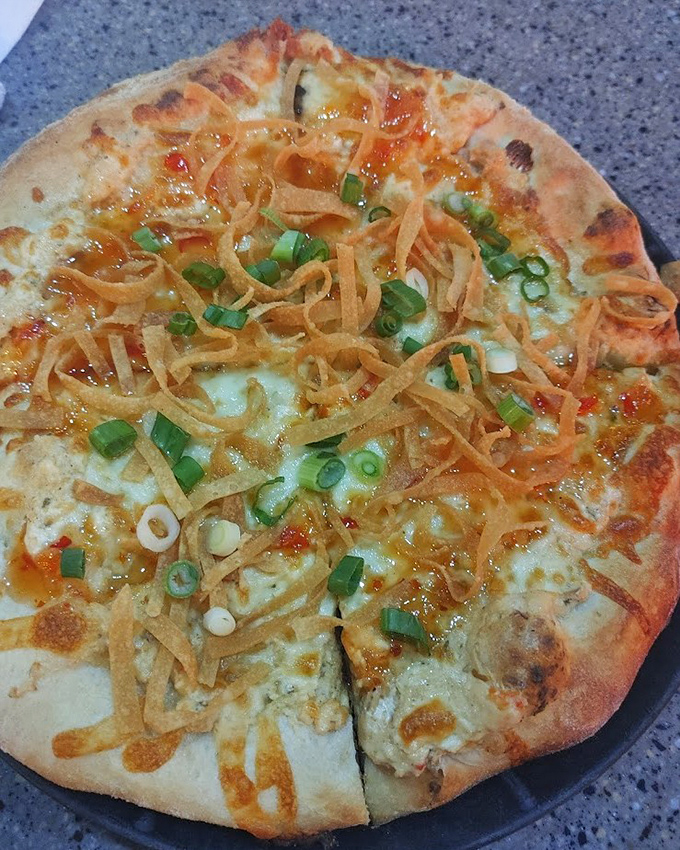 This specialty pizza with crispy wonton strips and green onions isn't just a meal&mdash;it's a conversation piece that happens to be delicious.