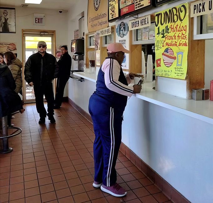 The lunch rush at Skyway—where Chicagoans from all walks of life unite in the democratic pursuit of hot dog perfection.